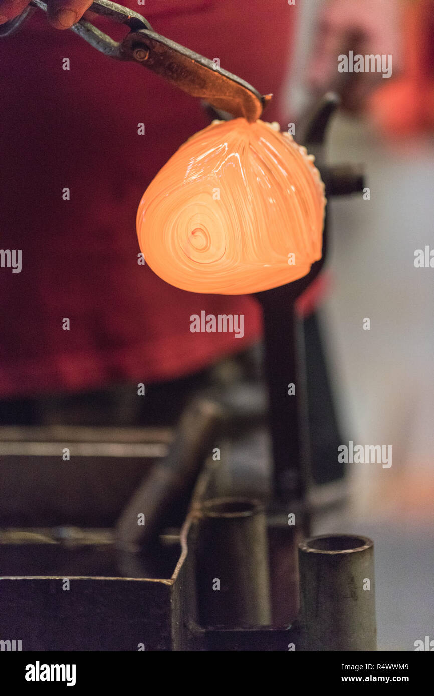 glass blower carefully forming hot glass to a decorative vase, germany ...