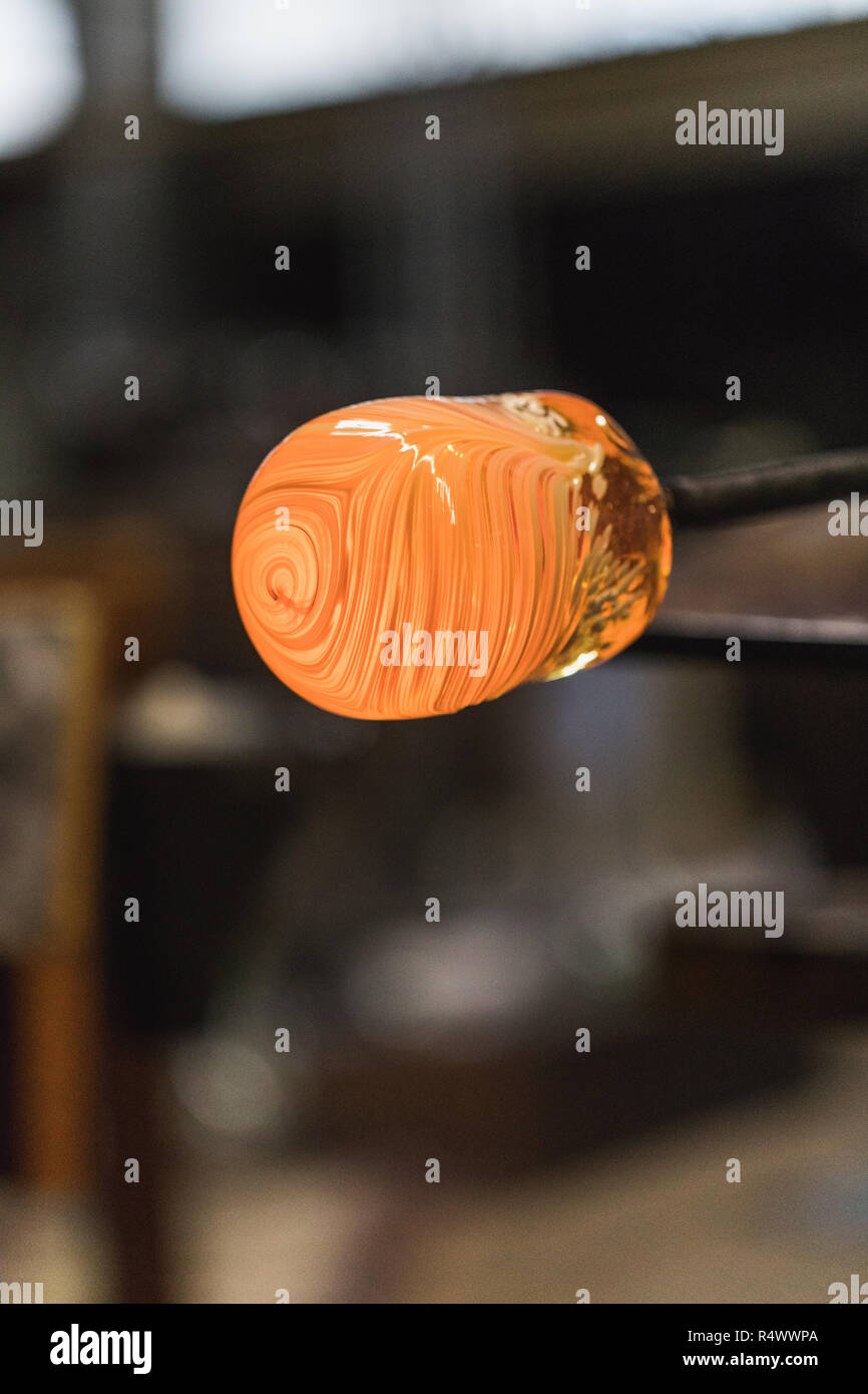 glass blower carefully forming hot glass to a decorative vase, germany ...