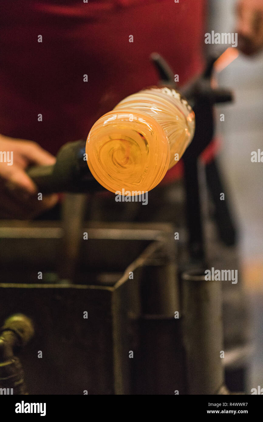 glass blower carefully forming hot glass to a decorative vase, germany ...