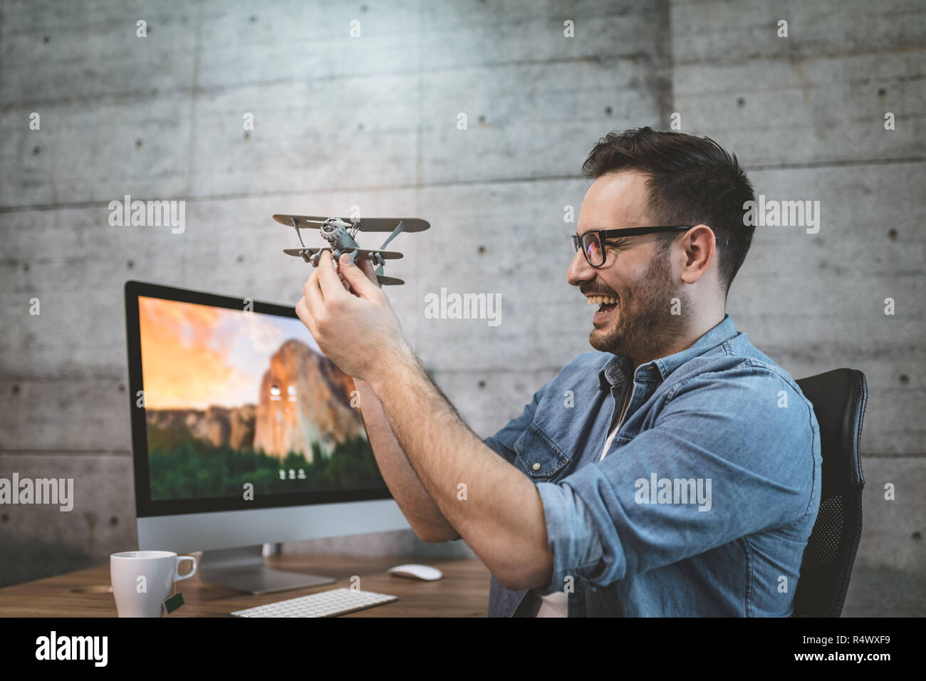 Young handsome successful smiling freelance entrepreneur having fun and ...