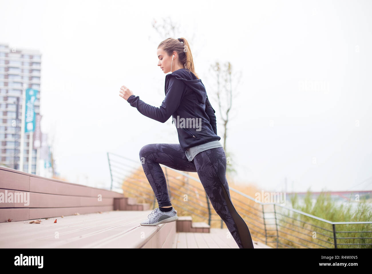 View at active young beautiful woman running in urban enviroment Stock ...