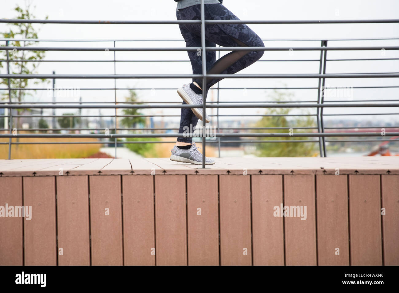 Young woman jumping fence hi-res stock photography and images - Alamy
