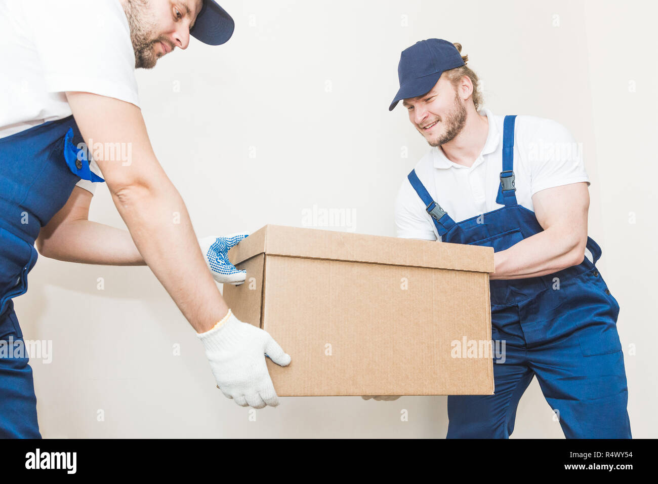Delivery man loading cardboard boxes for moving to an apartment ...