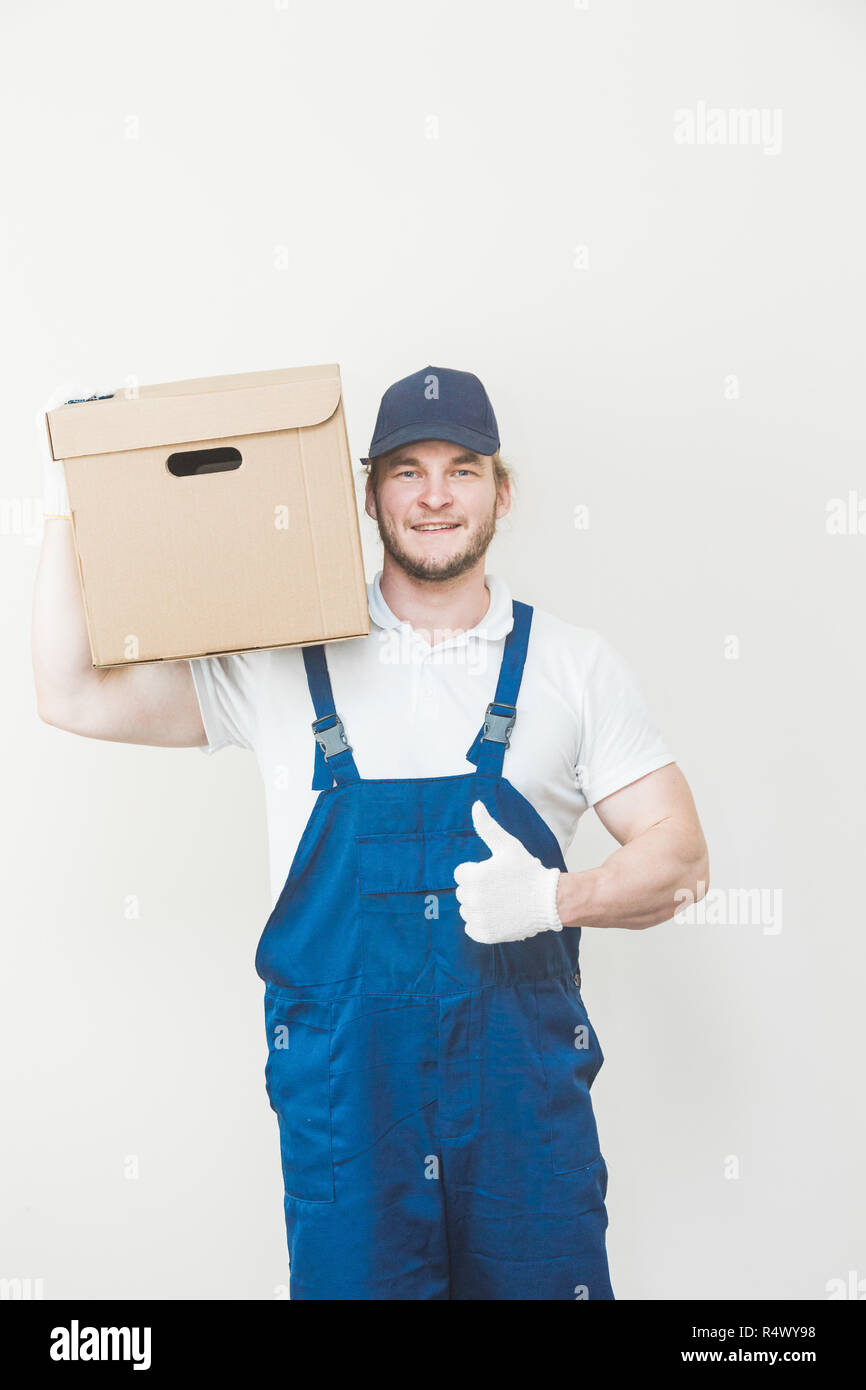 Delivery strong, muscular man loading cardboard boxes for moving to an ...