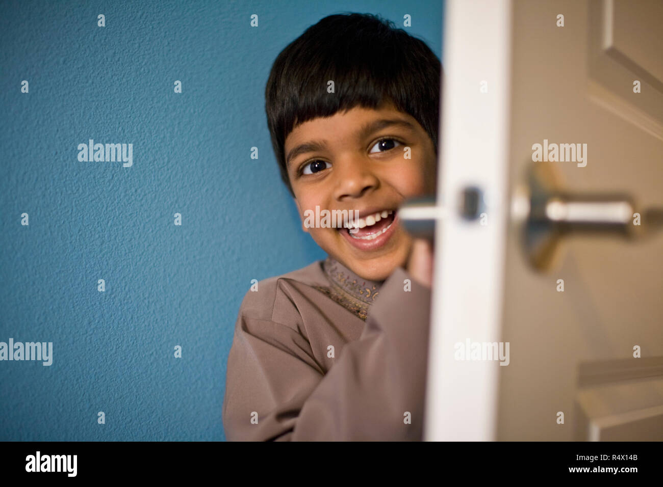 Boy hiding behind door hi-res stock photography and images - Alamy