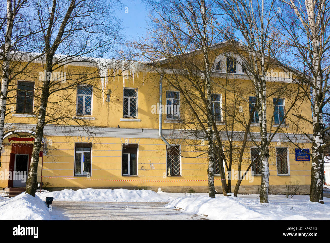 Large, long, sharp icicles hang from the roof of the house, sparkling ...