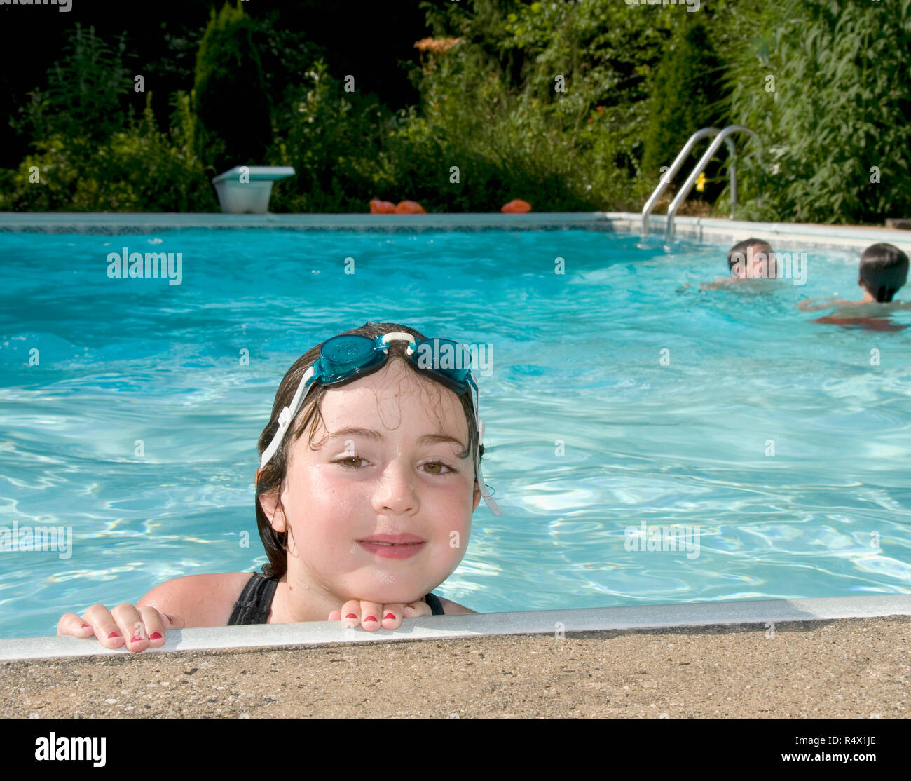 Kids playing in backyard swimming hi-res stock photography and images ...