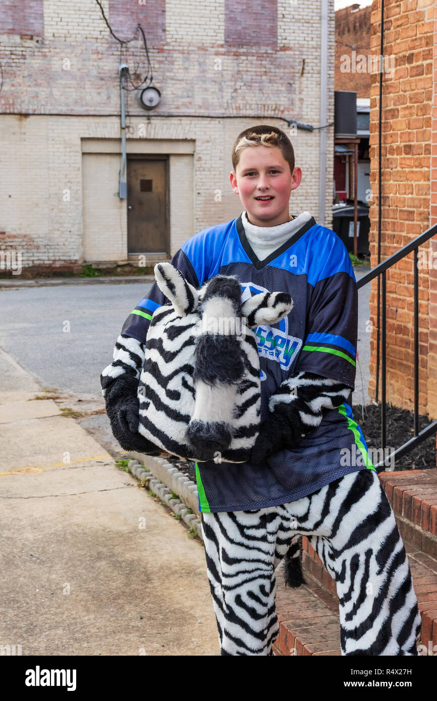 LINCOLNTON, NC, USA-11/25/18: Young man in zebra costume hold head in ...
