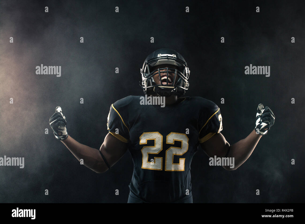 African American football player isolated on black Stock Photo - Alamy