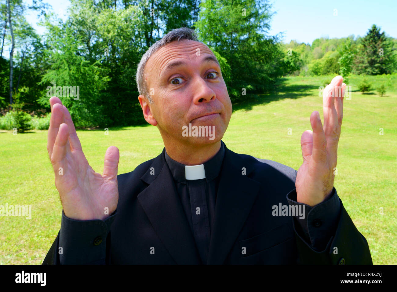 A Good Looking Catholic Priest Is Praying In His Garden He Looks At Us With Serenity Optimism