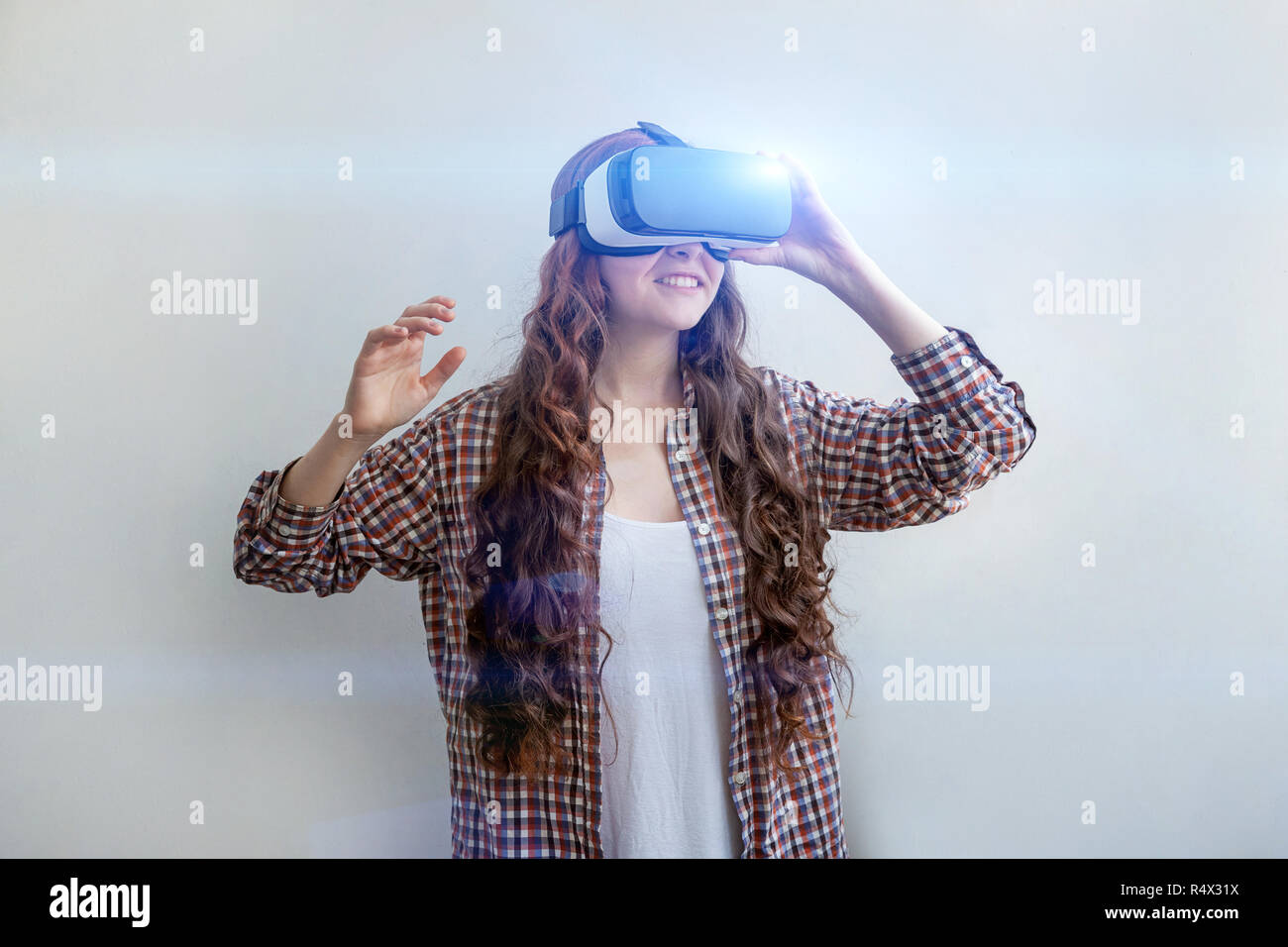 Smile young woman wearing using virtual reality VR glasses helmet ...