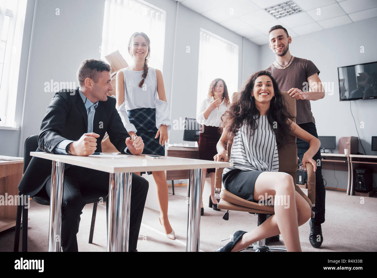 A group of business people celebrating, having fun, at the office Stock ...