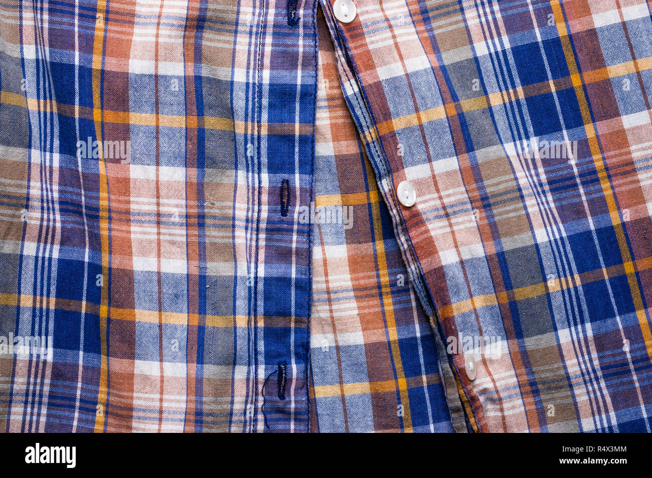 Textile texture of the checkered shirt, closeup the fastener useful as ...