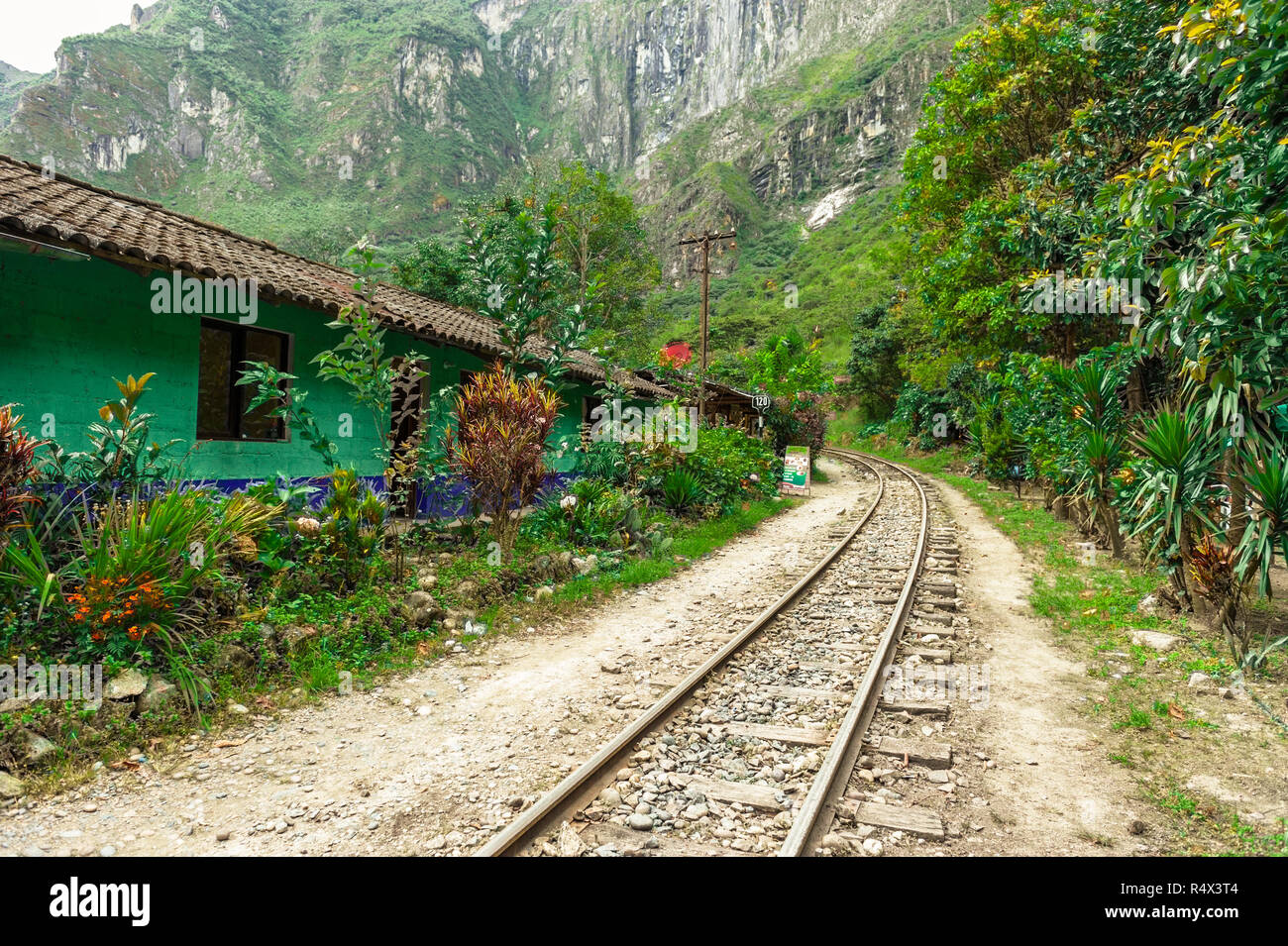 The railroad track crossing jungle and connecting Machu Picchu village ...