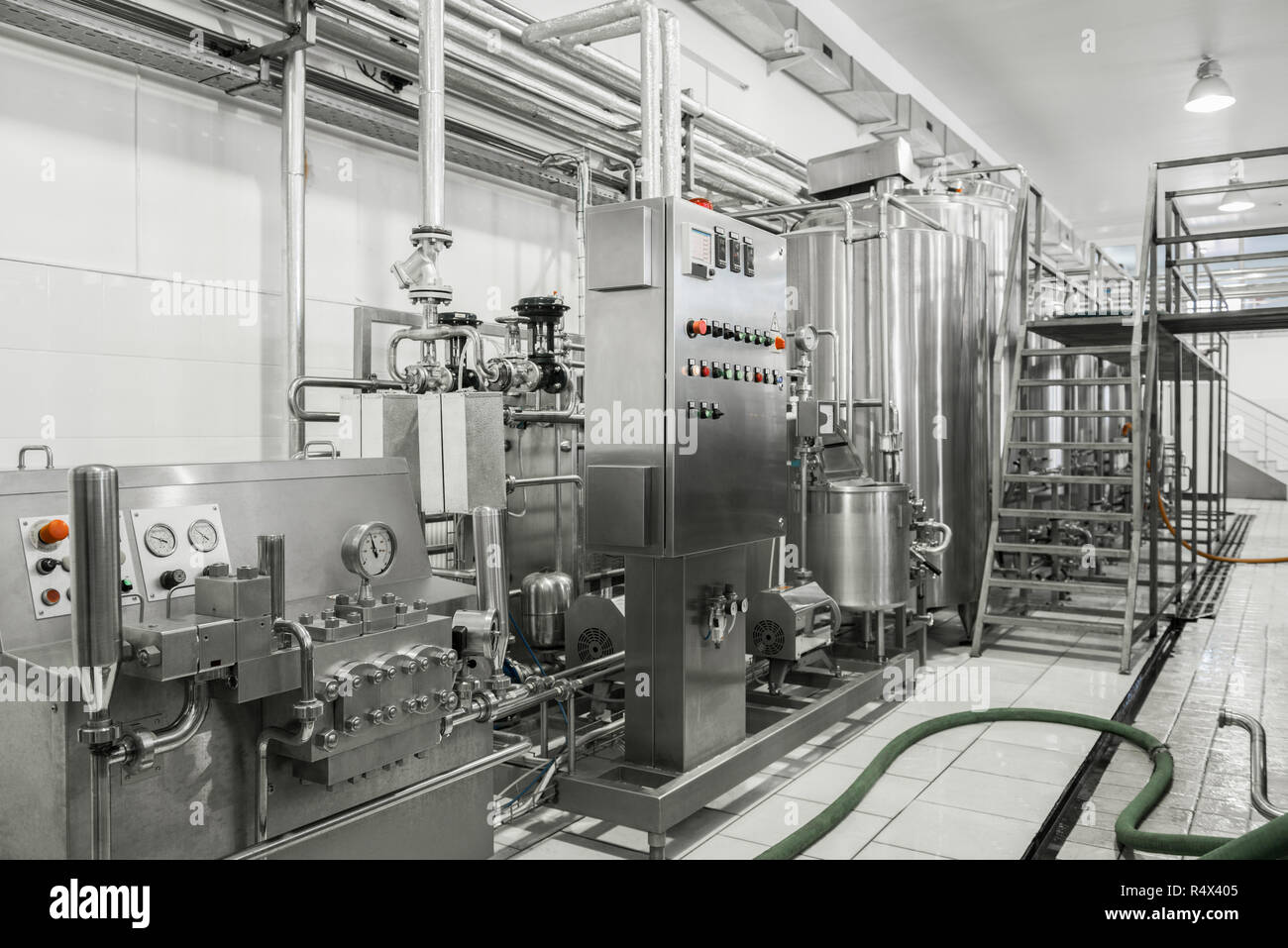 general view of the interior of a milk factory. equipment at the dairy ...