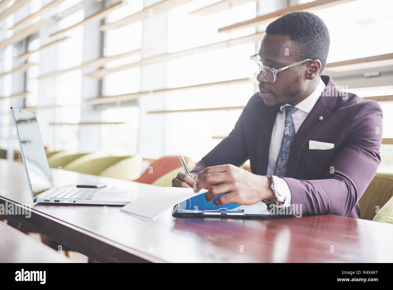 A young businessman signs a contract in a conference room Stock Photo ...