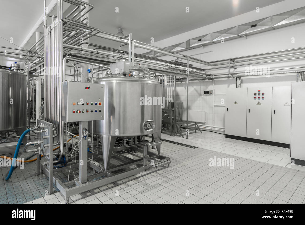 general view of the interior of a milk factory. equipment at the dairy ...
