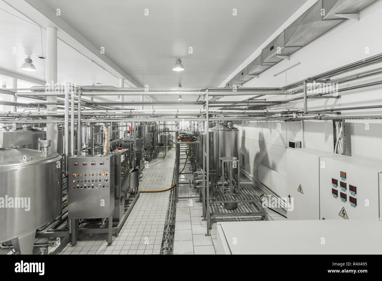general view of the interior of a milk factory. equipment at the dairy ...