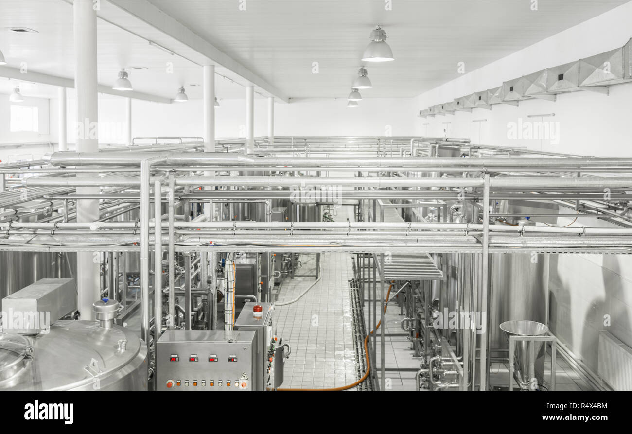 general view of the interior of a milk factory. equipment at the dairy ...
