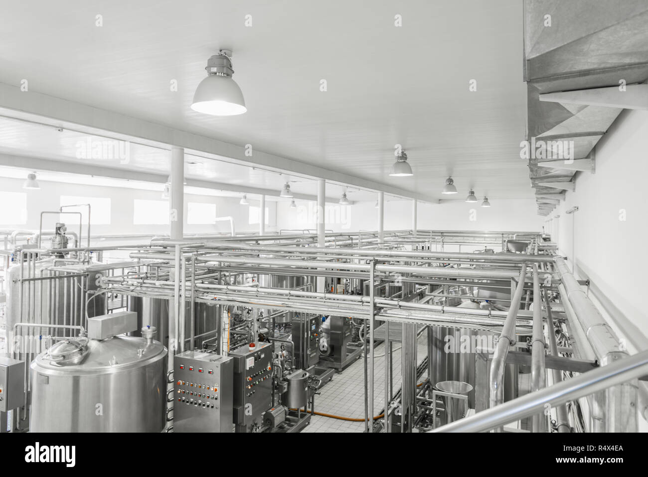 general view of the interior of a milk factory. equipment at the dairy ...