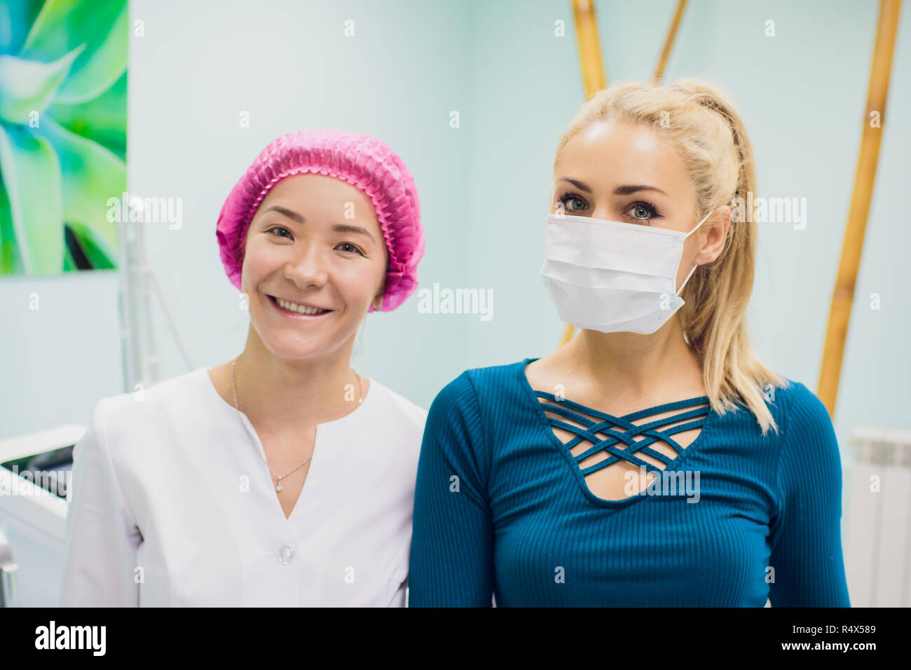 Smiling dermatologist enjoying appointment with patient in the hospital ...