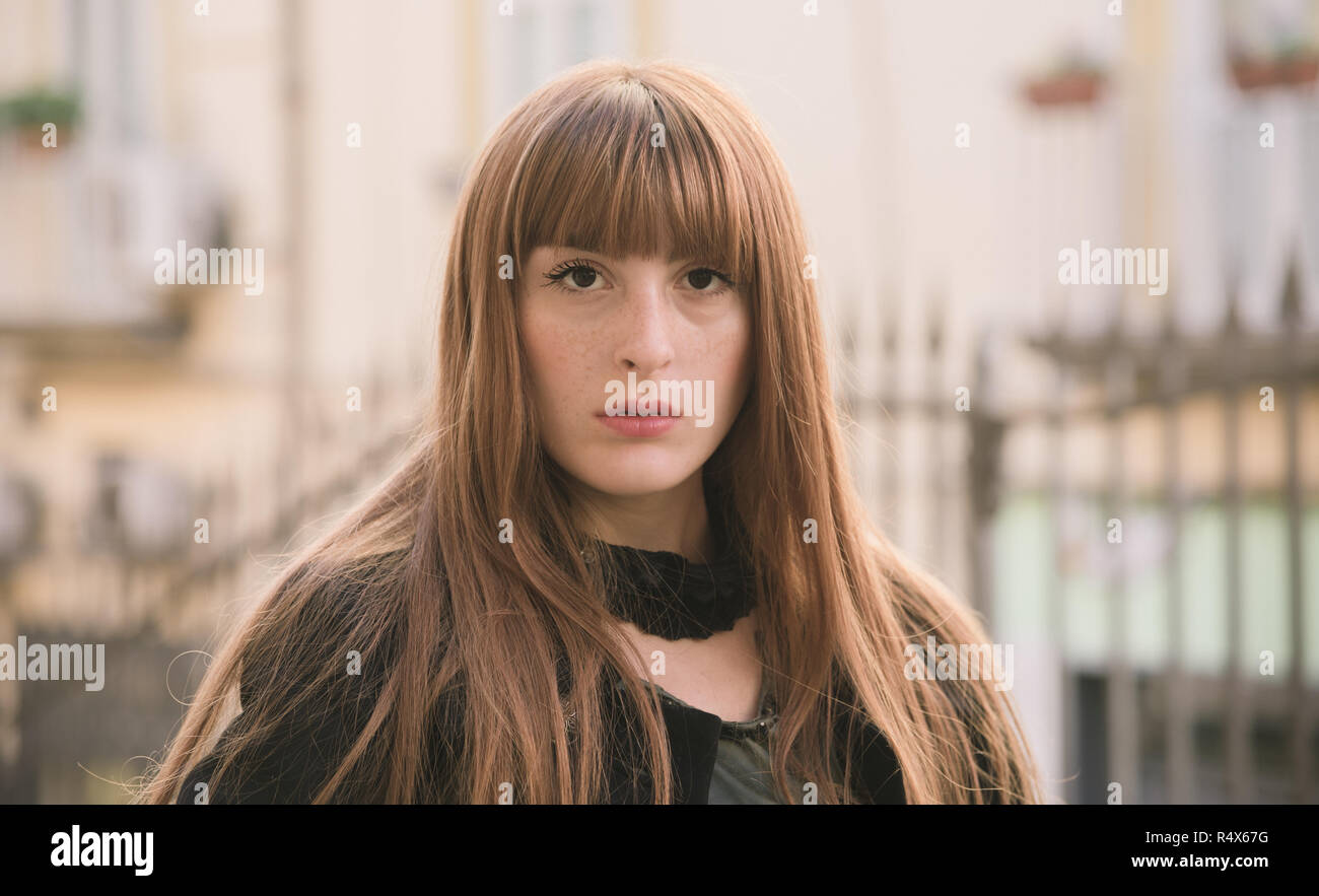 Young girl posing in street photography on outdoor urban scene in ...
