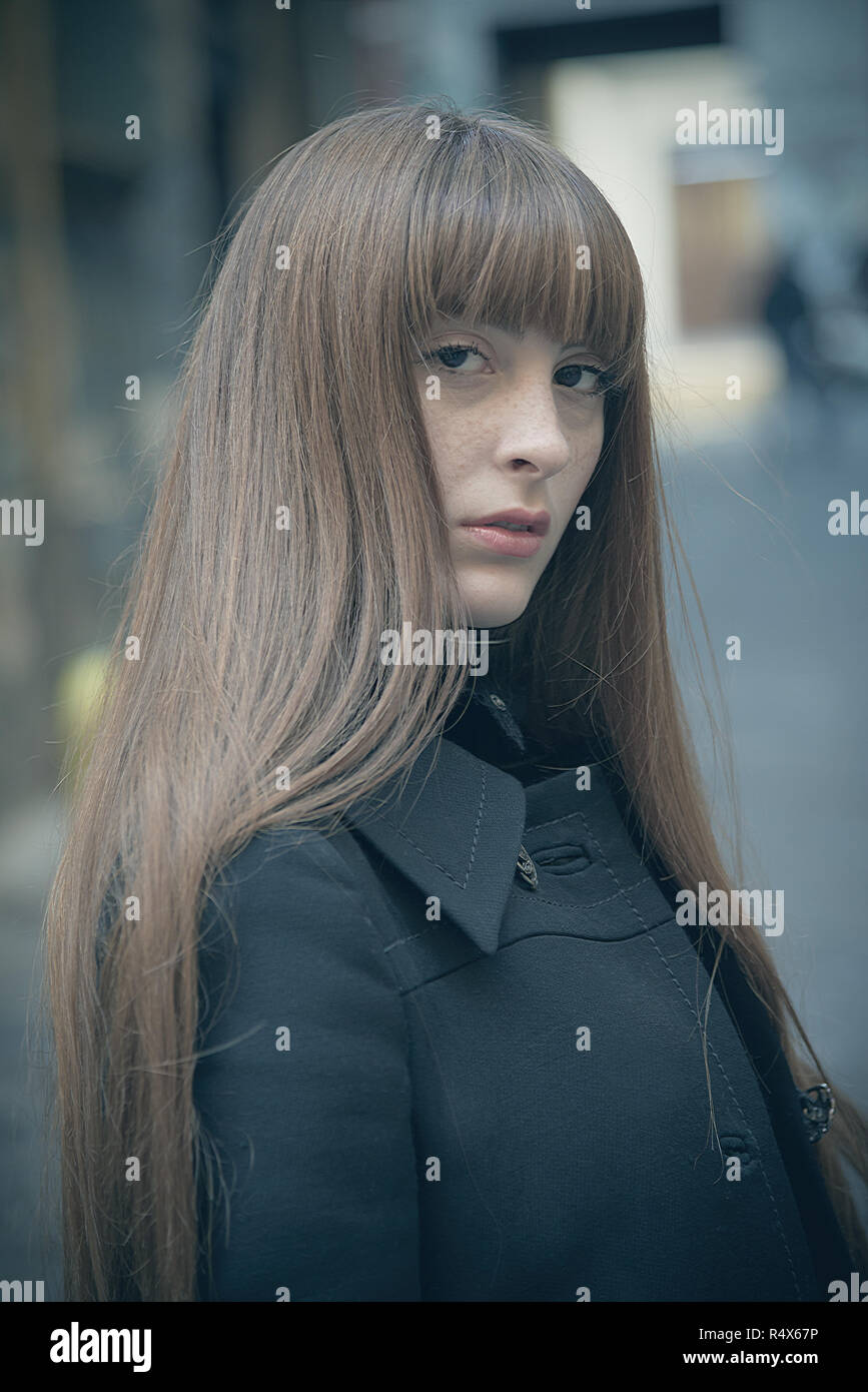 Young girl posing in street photography on outdoor urban scene in ...