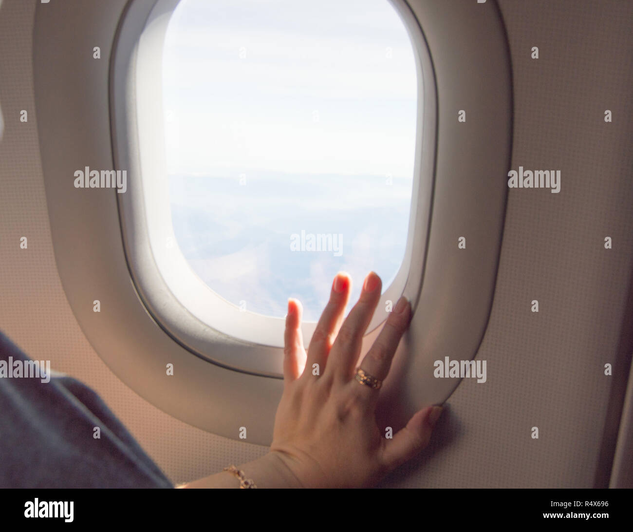 A female passenger of the flight sitting near the window, holding a ...