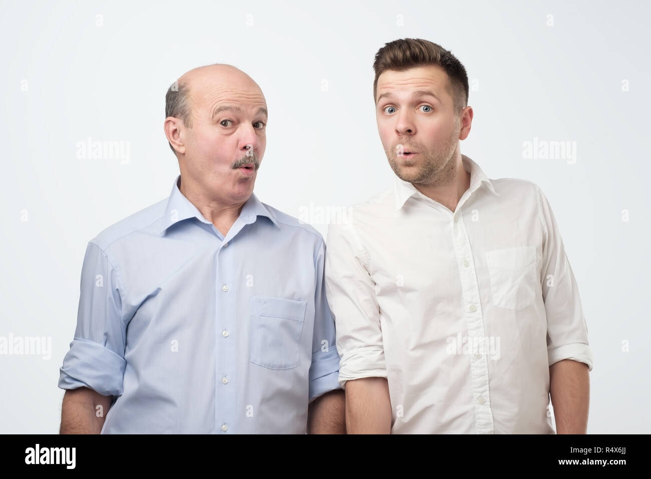 Amazed two mature men is shocked a little with news Stock Photo - Alamy