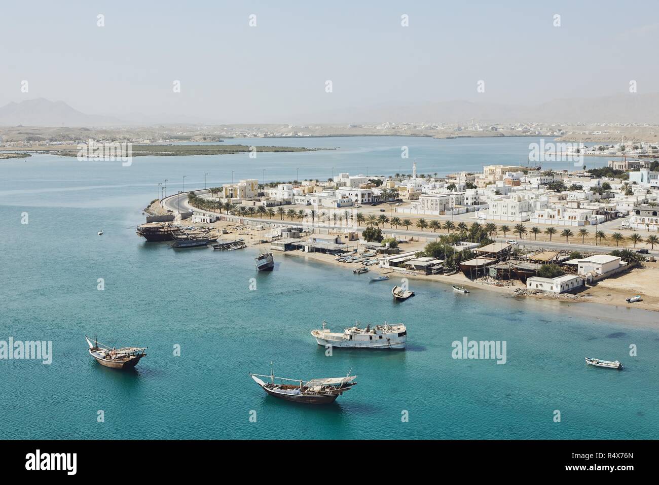 Bay with traditional wooden Dhow ships. Coastline of old city Sur in ...