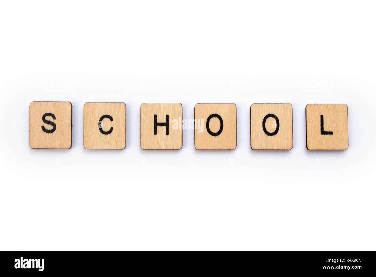 The word SCHOOL, spelt with wooden letter tiles Stock Photo - Alamy