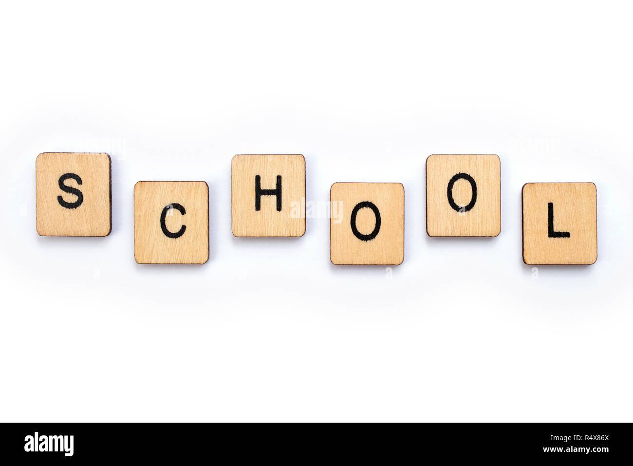 The word SCHOOL, spelt with wooden letter tiles Stock Photo - Alamy