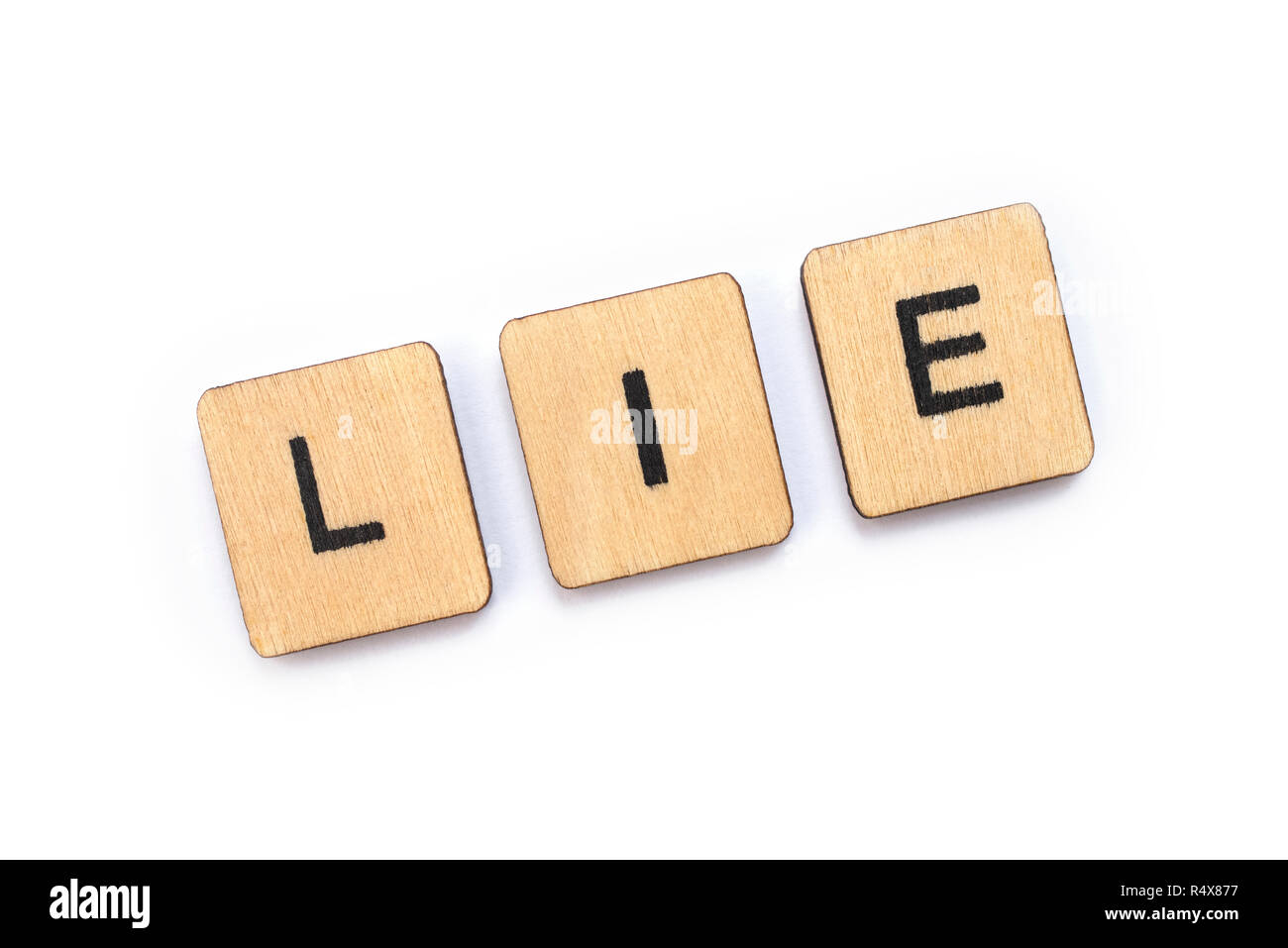 The word LIE, spelt with wooden letter tiles Stock Photo - Alamy