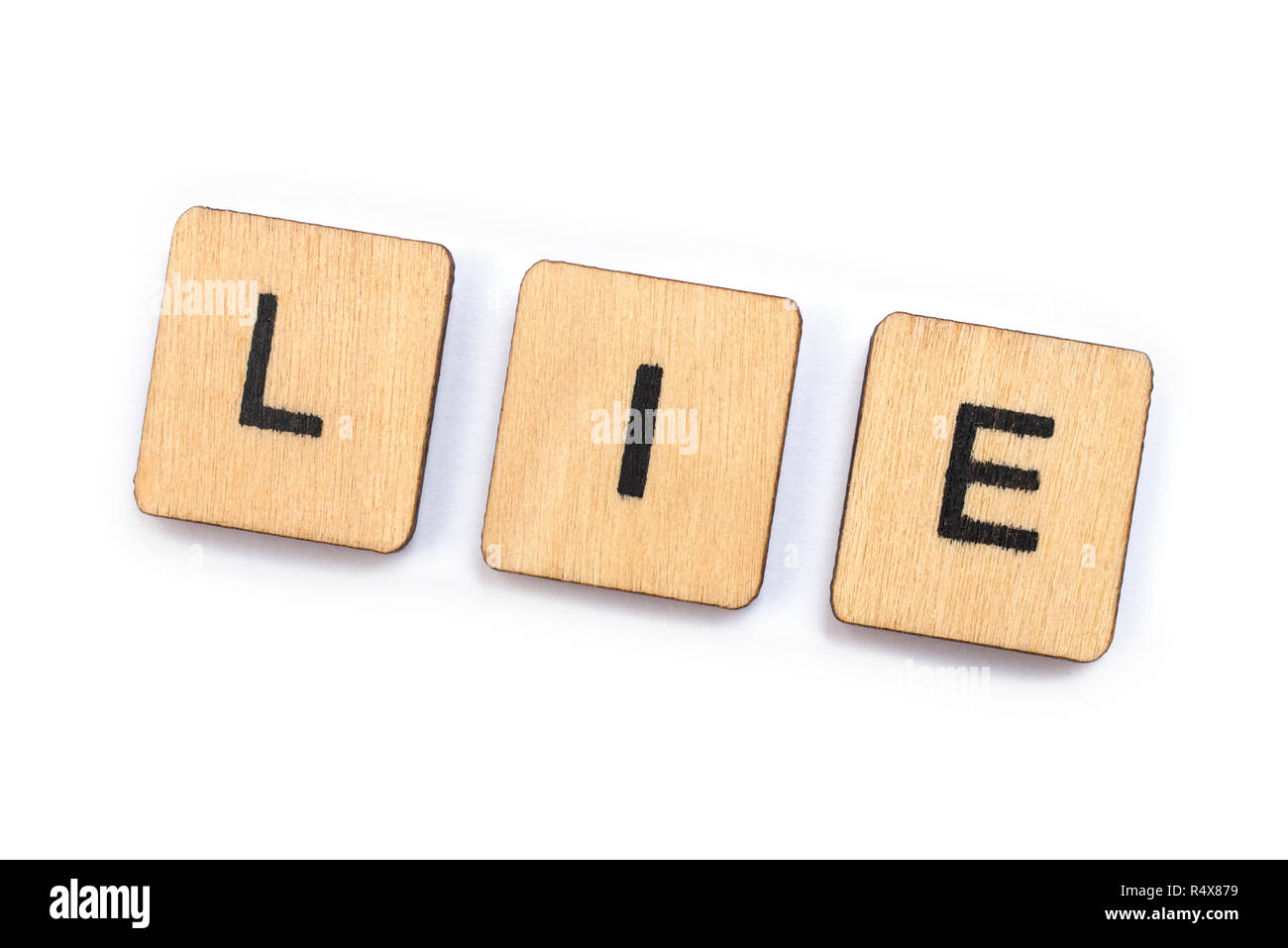 The word LIE, spelt with wooden letter tiles Stock Photo - Alamy