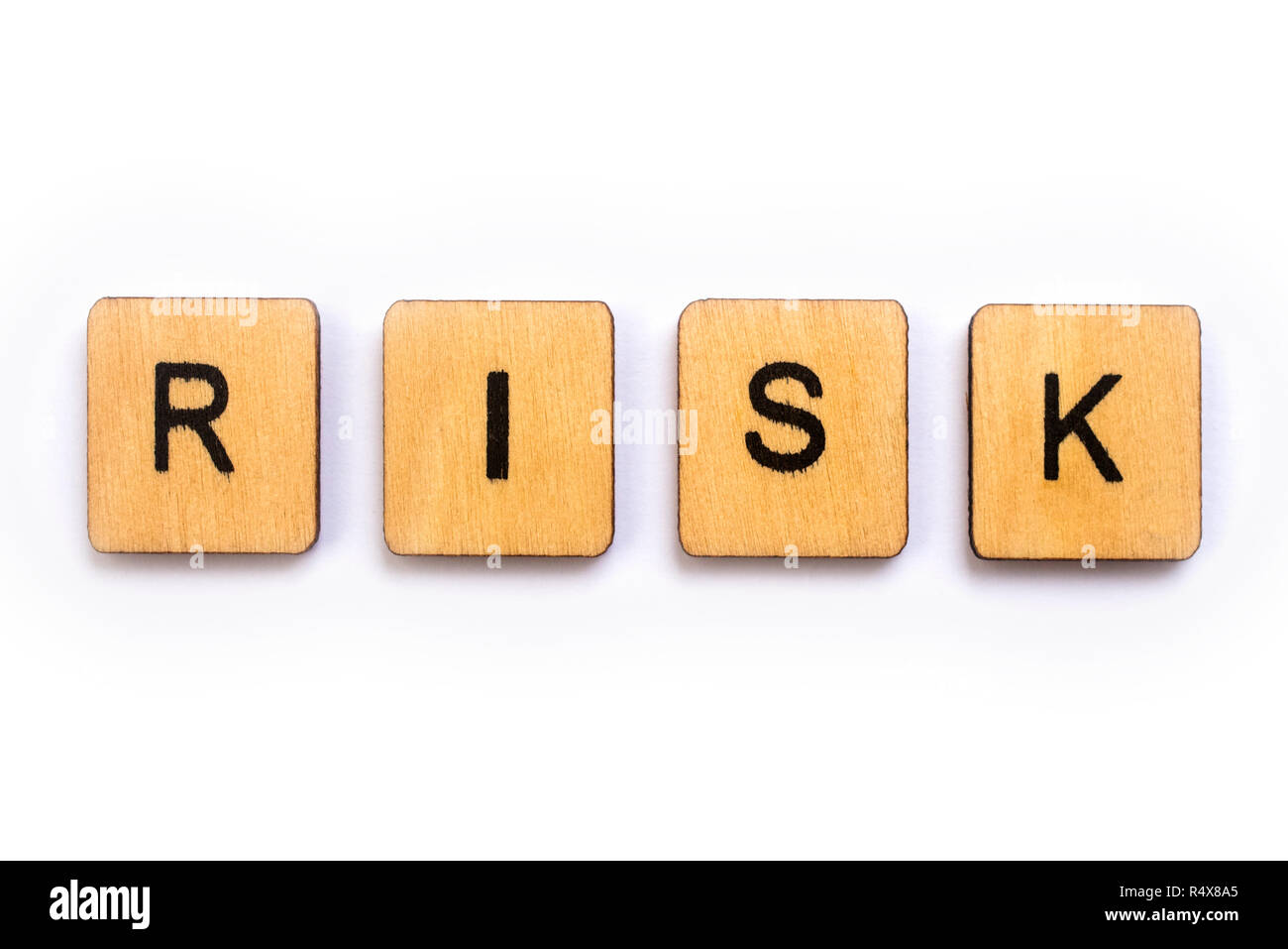 The word RISK, spelt with wooden letter tiles Stock Photo - Alamy