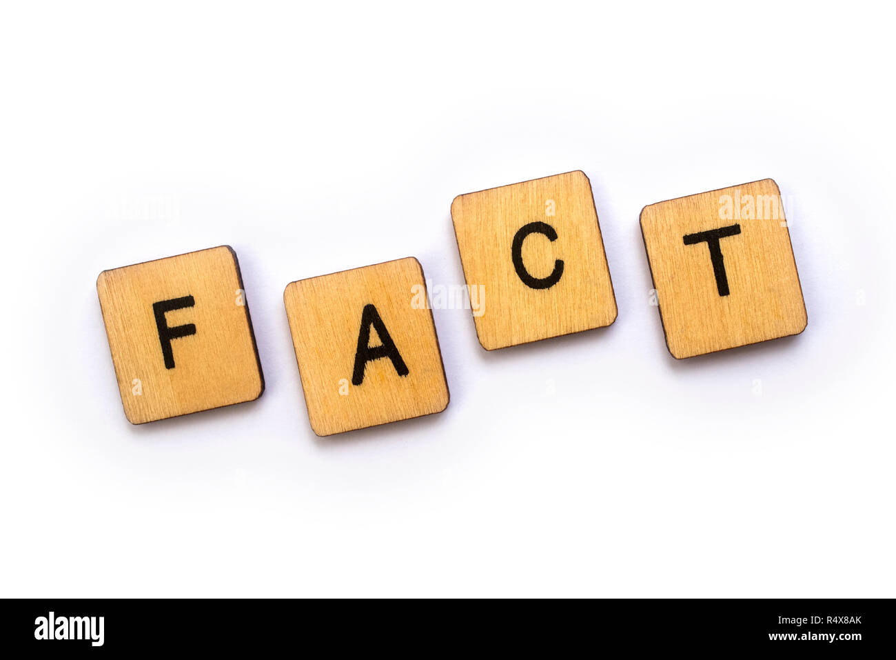 The word FACT, spelt with wooden letter tiles Stock Photo - Alamy