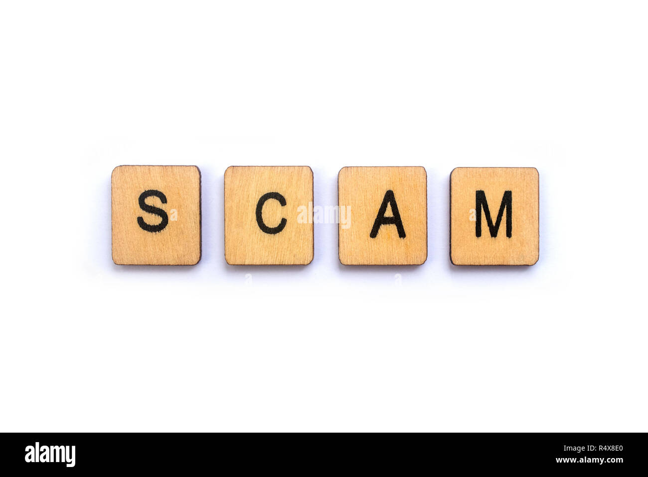 The word SCAM, spelt with wooden letter tiles Stock Photo - Alamy