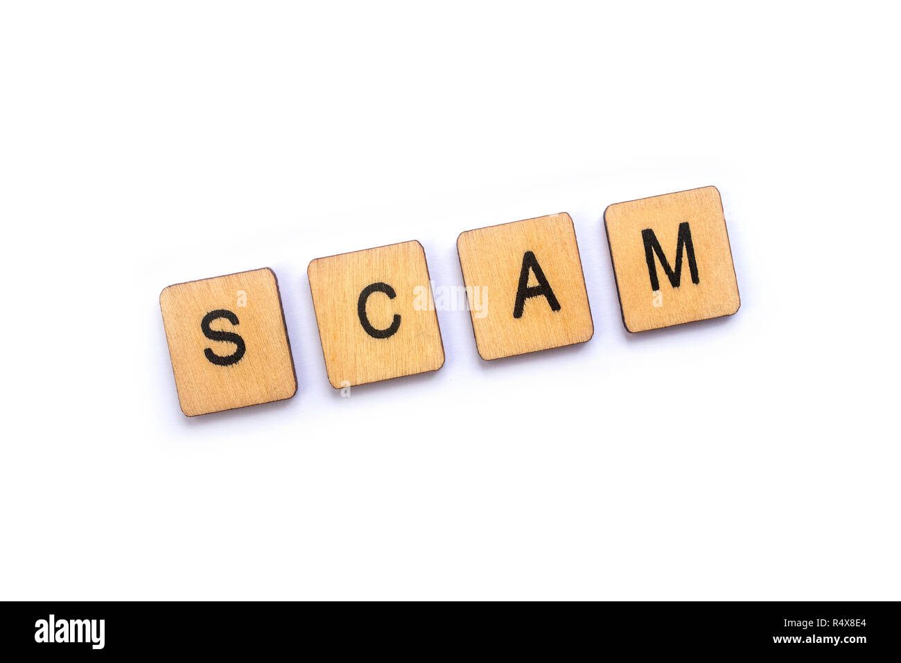 The word SCAM, spelt with wooden letter tiles Stock Photo - Alamy