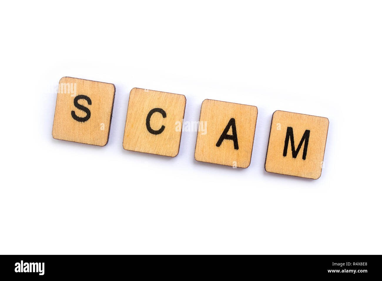 The word SCAM, spelt with wooden letter tiles Stock Photo - Alamy