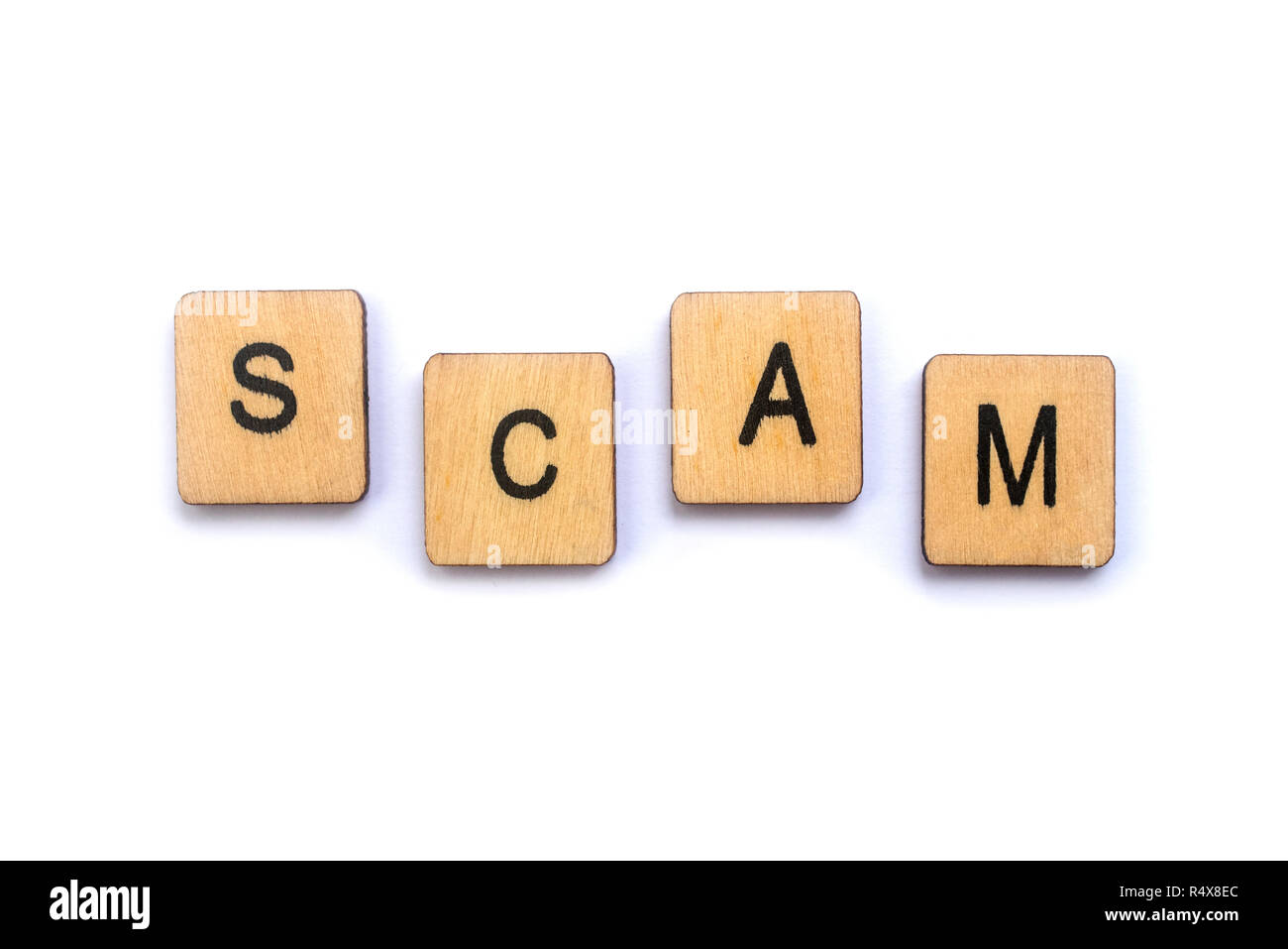 The word SCAM, spelt with wooden letter tiles Stock Photo - Alamy