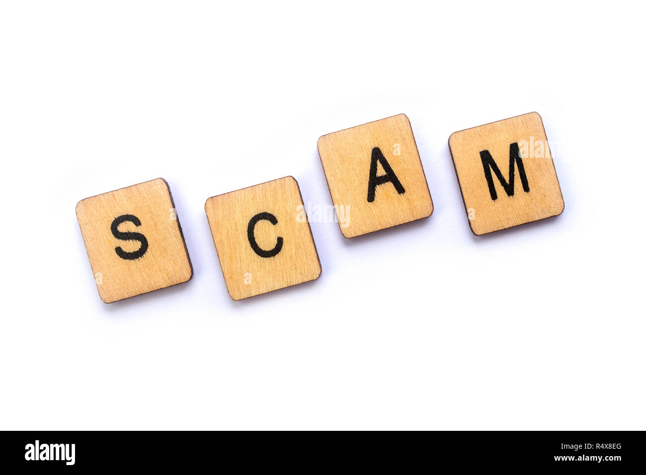 The word SCAM, spelt with wooden letter tiles Stock Photo - Alamy