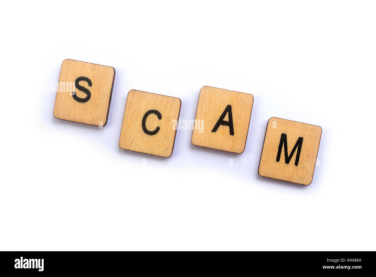 The word SCAM, spelt with wooden letter tiles Stock Photo - Alamy