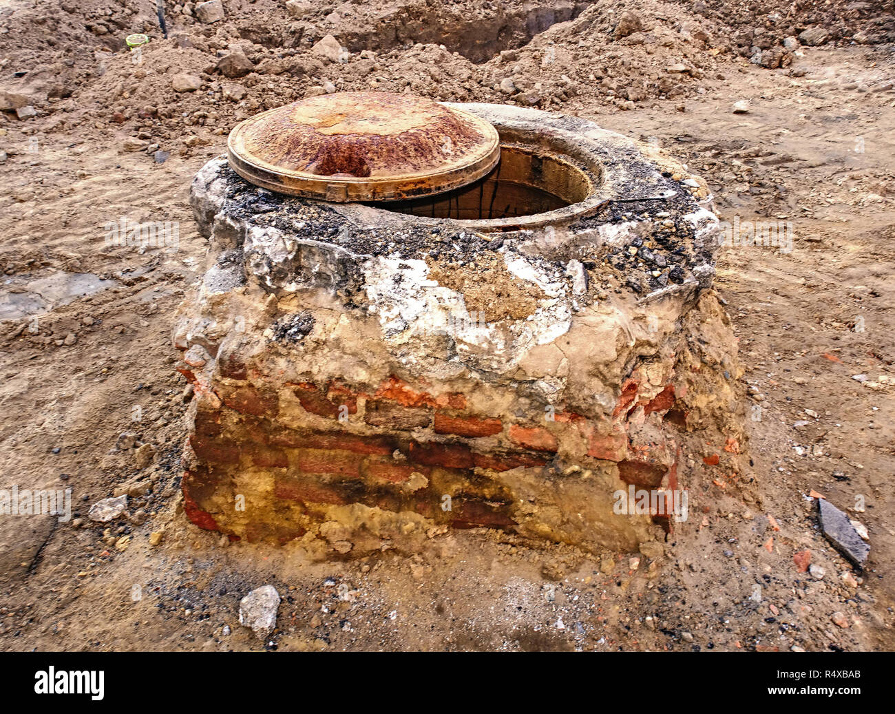 Rebuilding of street, broken manhole with steel cover. Manhole with ...