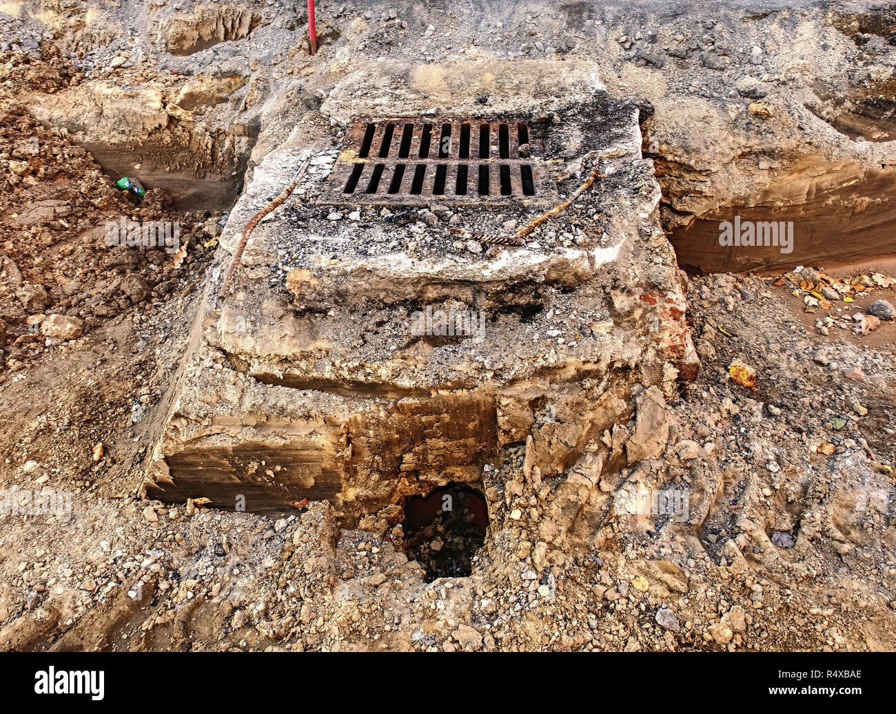 Sewer hole with cover in middle of square under reconstruction. Semi ...