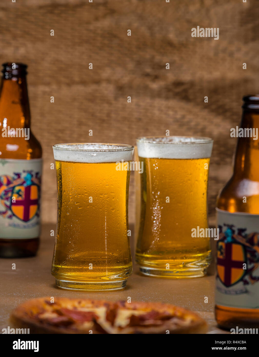 two beer bottles and glasses in pub bar restaurant, various concepts ...