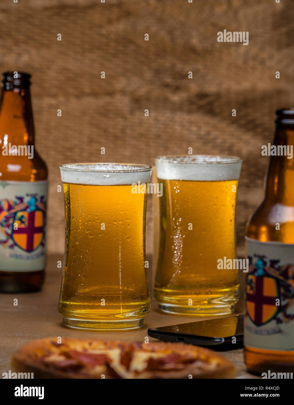 two beer bottles and glasses in pub bar restaurant, various concepts ...