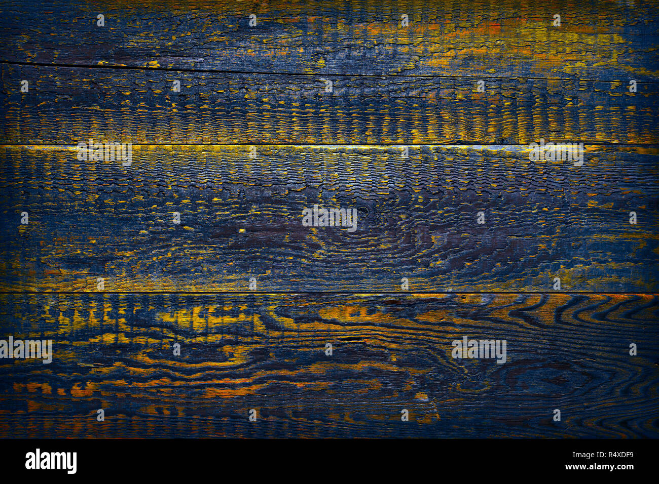 Wall of old charred boards as a background. Blue and yellow Stock Photo ...