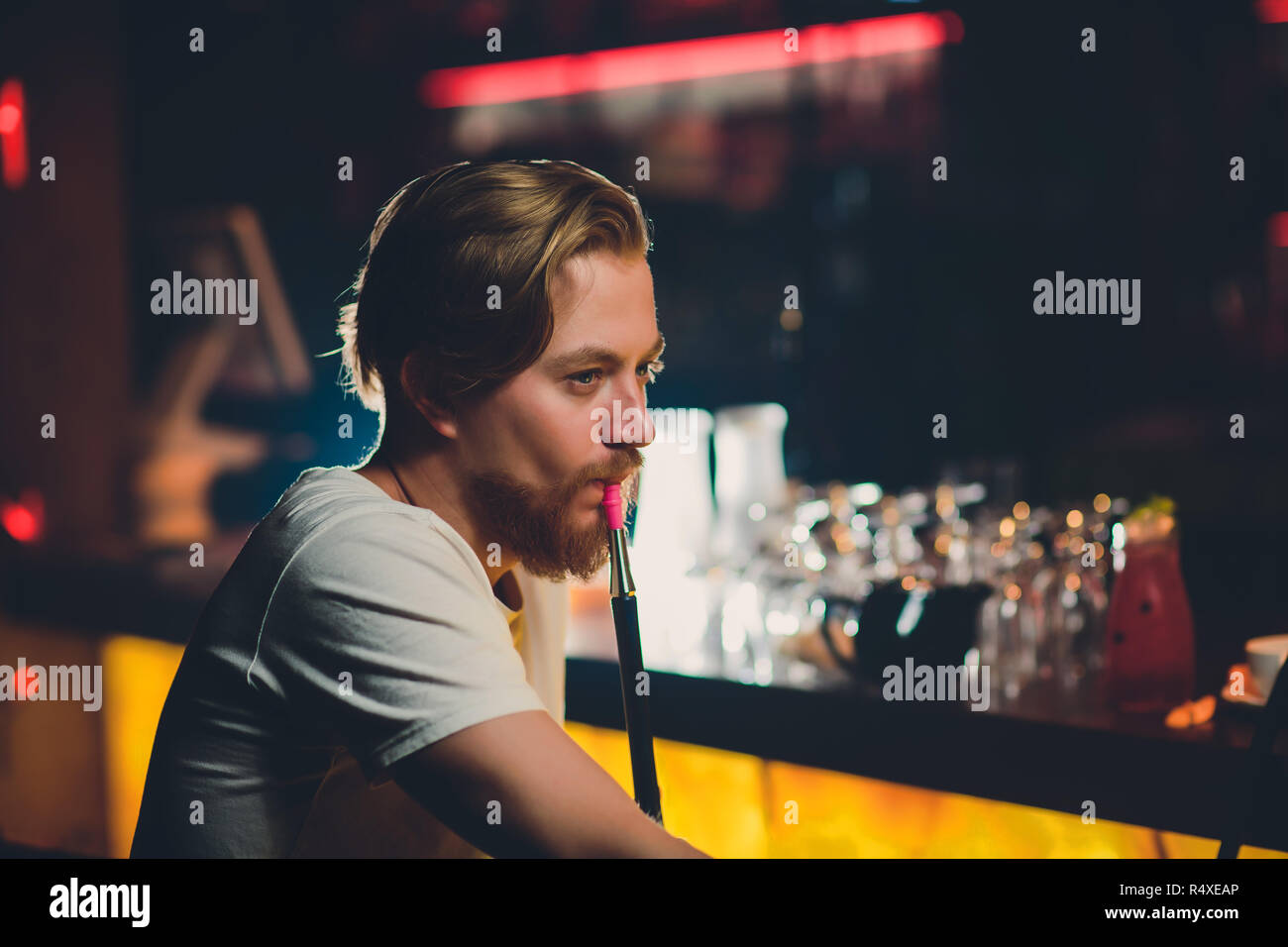 Young Man Smoking Shisha At Arabic Restaurant - Man Exhaling Smoke ...