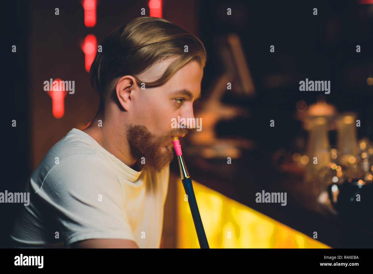 Young Man Smoking Shisha At Arabic Restaurant - Man Exhaling Smoke ...