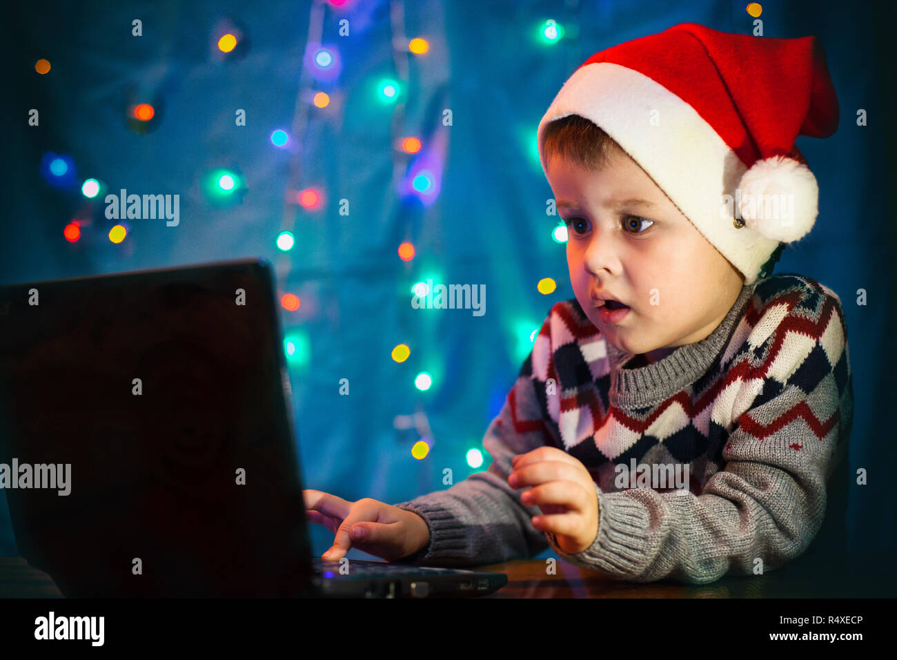 Little child writing letter to Santa Claus on laptop computer. Little ...